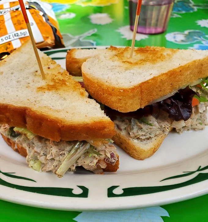 Behold the legendary tuna melt in all its glory! Chunky filling, perfectly toasted bread, and that hint of green peeking out&mdash;sandwich perfection exists.