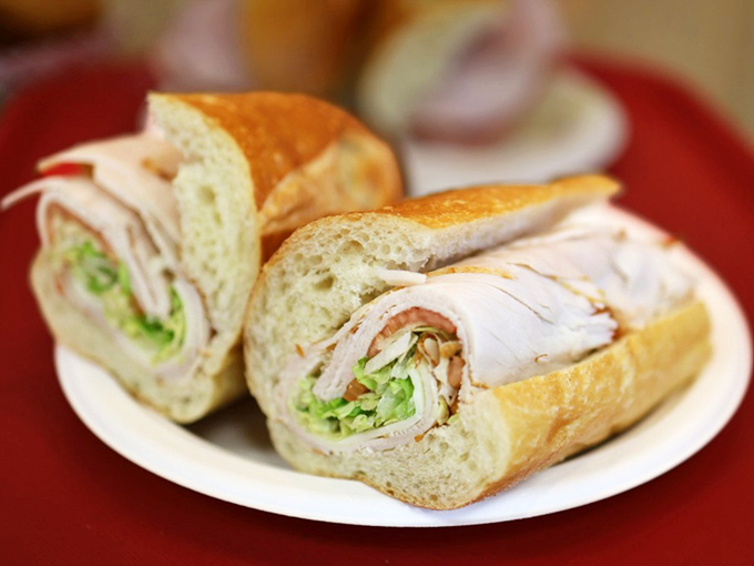 Behold the star attraction: layers of turkey, crisp veggies, and that perfect bread&mdash;architecture you can eat without a building permit.