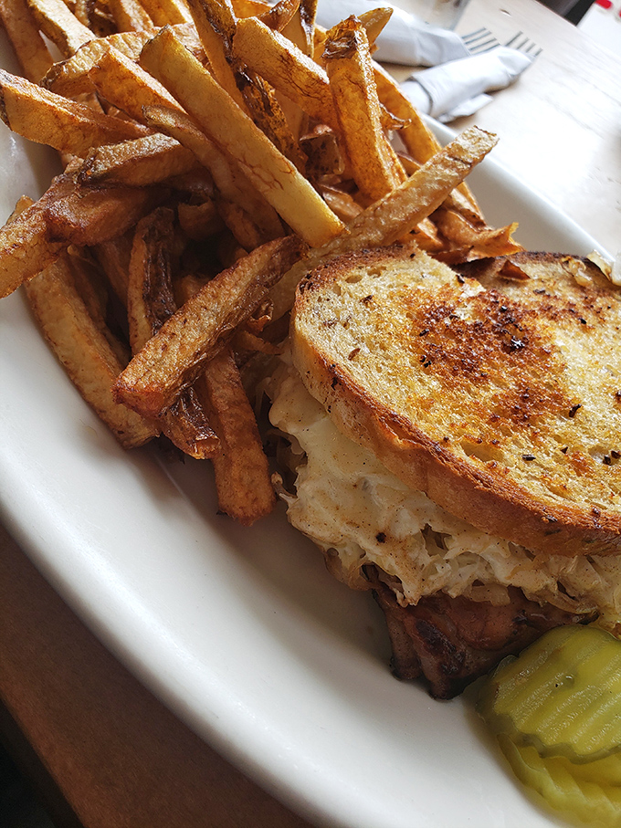 This isn't just a sandwich; it's architecture. Golden-grilled rye supporting the perfect ratio of turkey, sauerkraut, and Swiss, with hand-cut fries standing guard.
