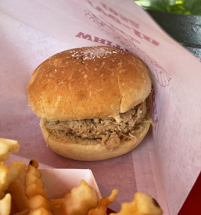 The signature turkey sandwich arrives unassuming yet magnificent. Tender shredded turkey on a pillowy bun&mdash;proof that simplicity, when done right, is culinary poetry.