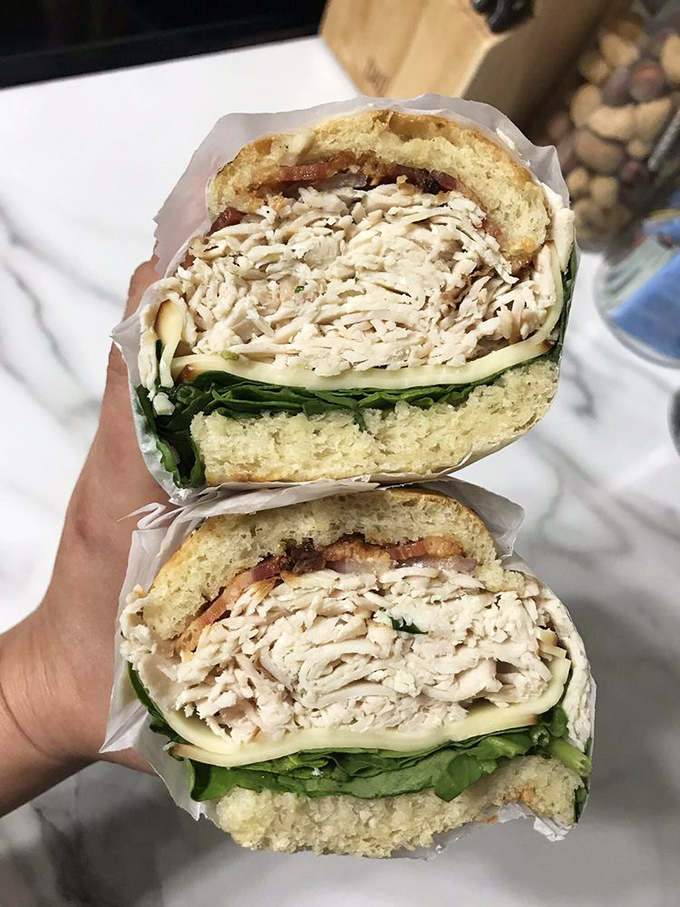 Behold the legendary Smoked Turkey Club – layers of house-smoked meat, fresh spinach, and smoked gouda creating what might be Ohio's most perfect sandwich.