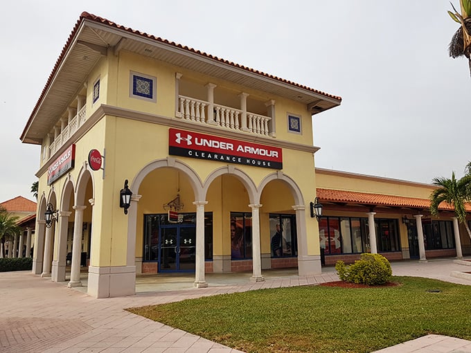 Under Armour's storefront embodies the outlet's architectural charm—where athletic aspirations meet vacation budgets in perfect harmony.