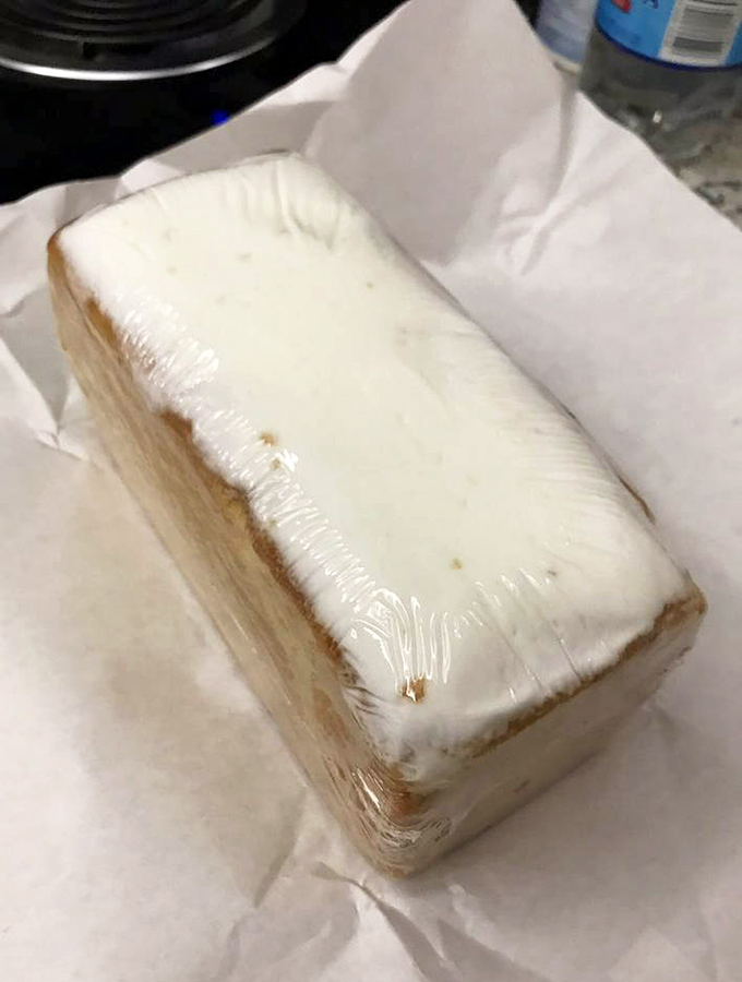 The holy grail of pound cake &ndash; wrapped in plastic like the culinary treasure it is. Dense, moist, and worth every calorie.