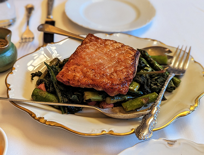 The legendary venison scrapple &ndash; crispy exterior giving way to a rich, savory interior atop seasonal greens. Worth every mile of the journey.