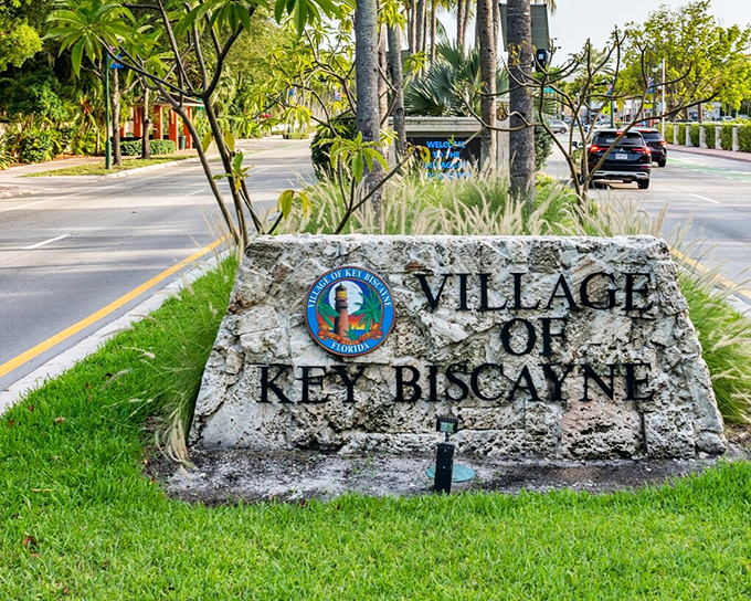The Village of Key Biscayne welcomes visitors with a coral rock sign that might as well read "Stress Prohibited Beyond This Point."