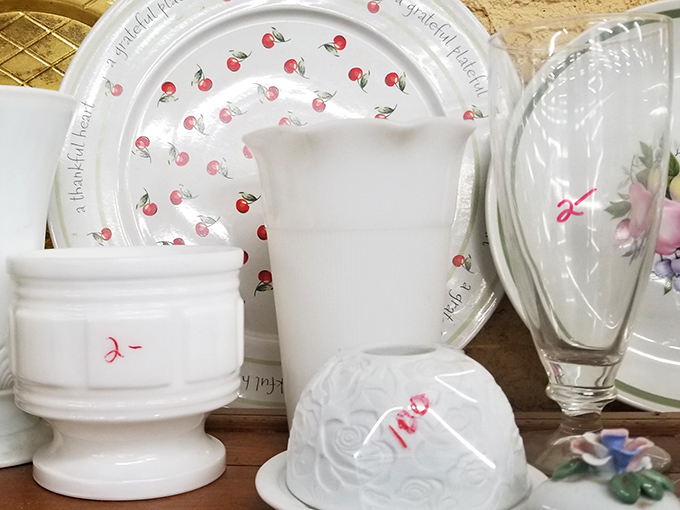 Delicate cherry-patterned plates and milk glass treasures wait patiently for someone to complete their collection or start a new one.