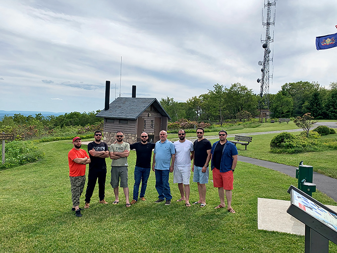 The summit gathering spot where strangers become temporary friends, united by that universal "can you believe this view?" expression we all share.