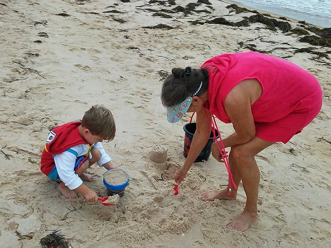 Sandcastle architects at work! The beach doubles as both canvas and playground where memories are built one bucket at a time.