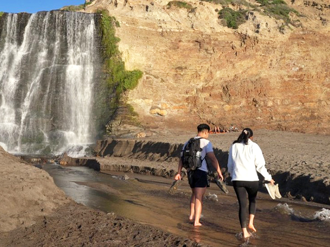 Barefoot pilgrims at journey's end. After an 8-mile round trip hike, dipping your toes in the falls' outflow feels like nature's reward system.
