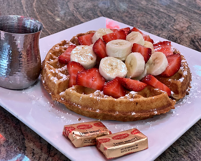 Breakfast nirvana exists, and it looks exactly like this golden waffle crowned with fresh strawberries and bananas, glistening with syrup.
