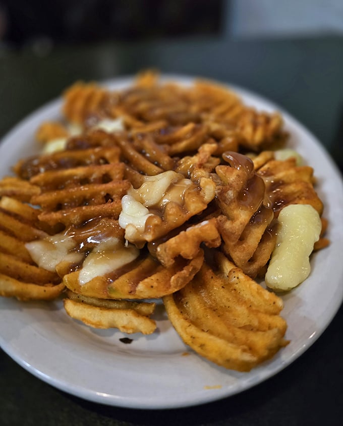 Golden waffle fries arrive crispy and perfect, ready to soak up every drop of wing sauce.