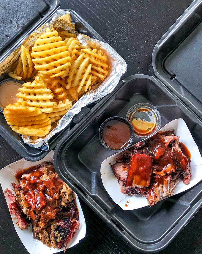 Waffle fries and pulled pork with sauce options—proof that sometimes the best relationships are the ones that start on the same plate.