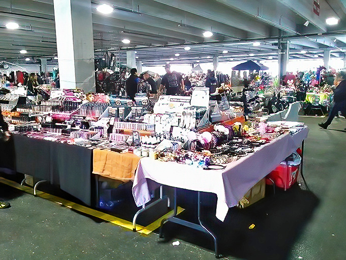 Tables laden with colorful merchandise create a landscape of potential purchases. One person's random assortment is another's perfect find.