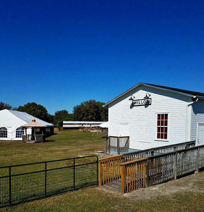 The charming Willow depot stands as a pristine time capsule, its white clapboard siding and wooden platform whispering stories from Florida's railroad past.
