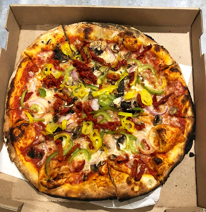 Behold the leopard-spotted beauty of proper wood-fired pizza &ndash; those char bubbles are flavor fireworks waiting to happen.