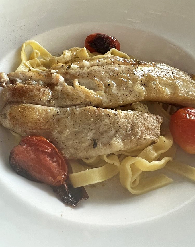 The legendary yellowtail snapper that's worth the drive. Perfectly flaky fish nestled on pasta with roasted tomatoes &ndash; simplicity that speaks volumes.