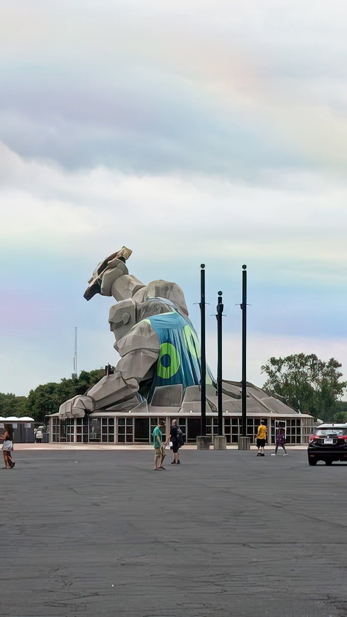 From behind, Miles reveals his true scale against the Delaware sky. That's not a backpack&mdash;it's a full-sized race car he's casually hoisting.