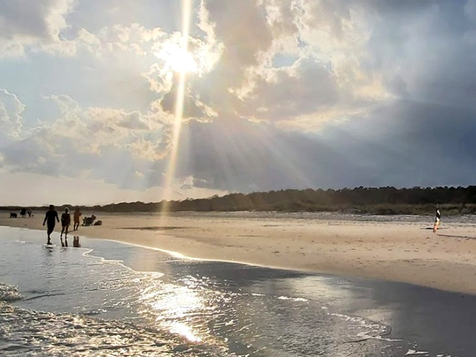 Heaven's spotlight on full display. When the clouds part like this at sunset, even the most dedicated beach walkers pause in reverent awe.