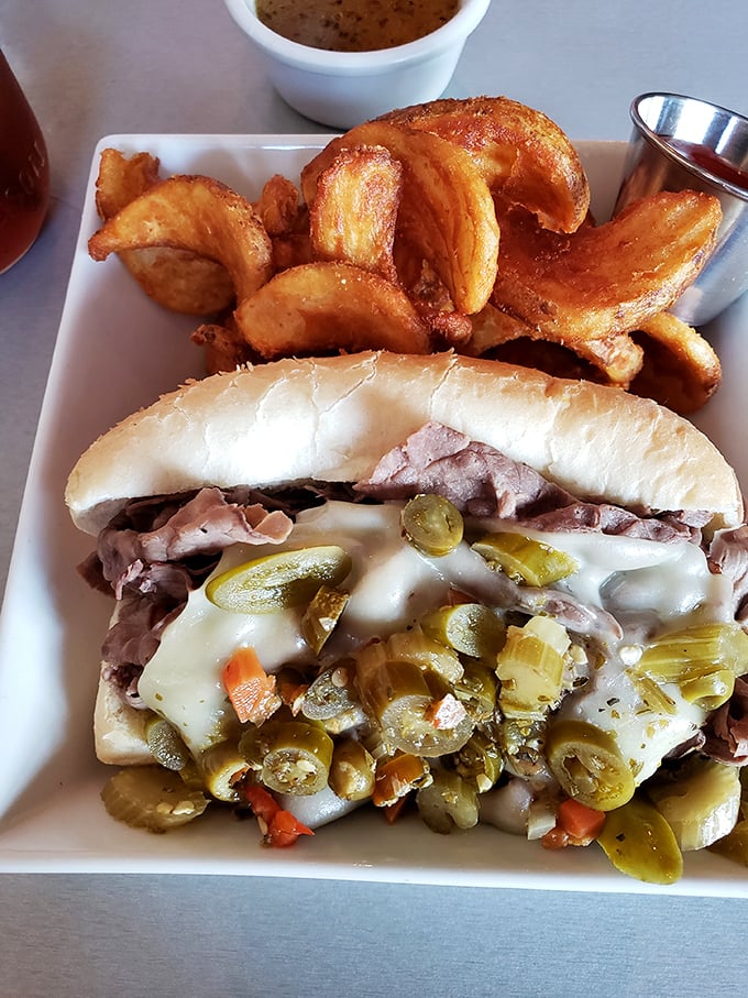 This isn't just a sandwich; it's architecture with pickles. The potato wedges aren't sides&mdash;they're co-stars in this delicious production.