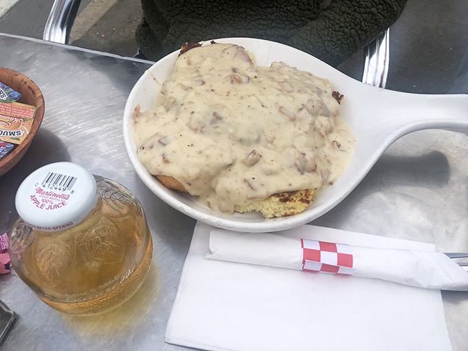 Behold the star attraction&mdash;biscuits drowning in peppery gravy that's studded with sausage bits, a comfort food masterpiece worth setting alarms for.