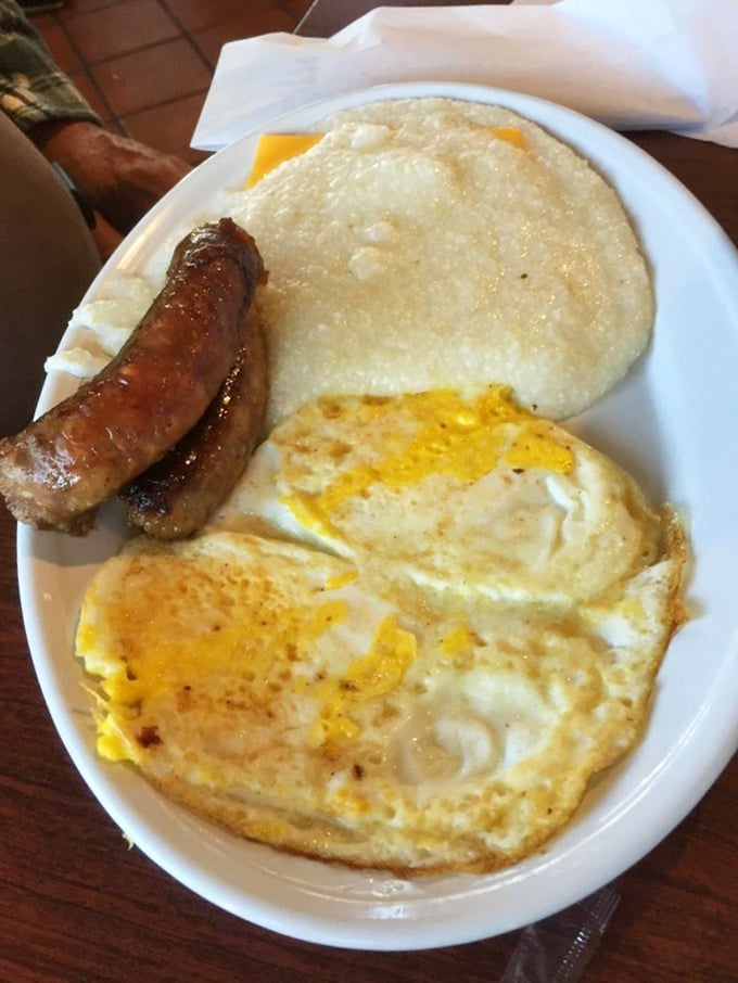 The holy trinity of breakfast: perfectly fried eggs, savory sausage links, and creamy grits. Simplicity that puts fancy brunch spots to shame. 