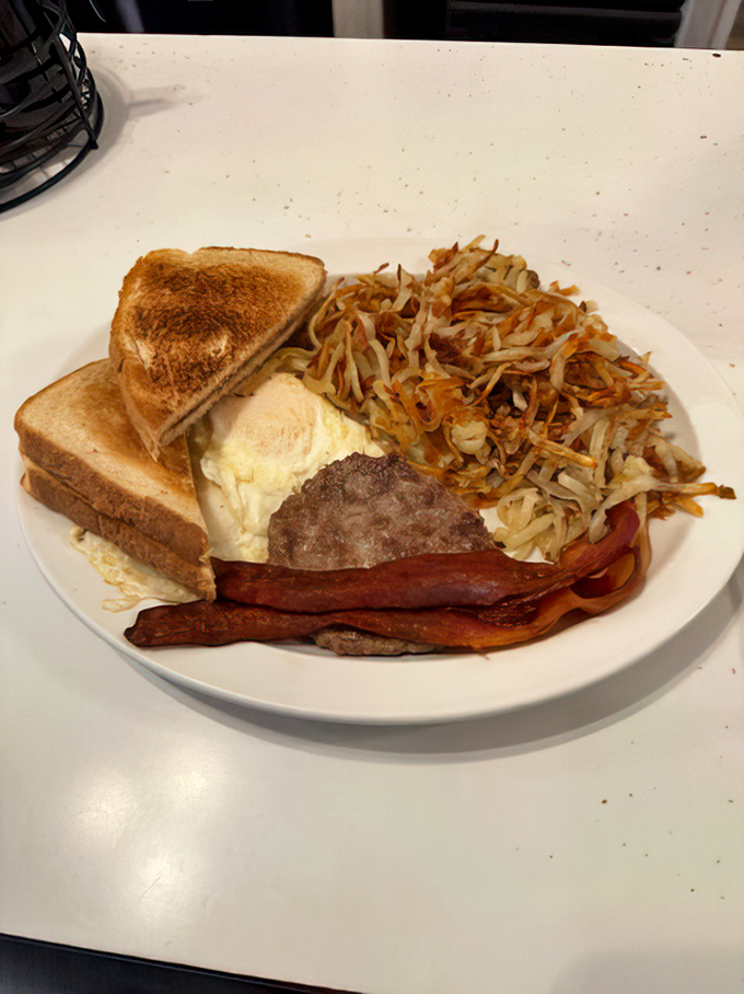 Perfectly golden hash browns, crispy bacon, and eggs cooked just right create breakfast perfection on a plate.