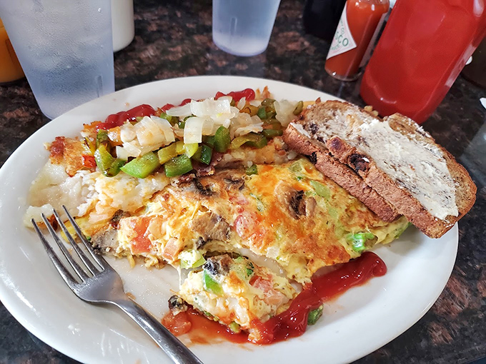 This isn't just an omelet—it's a morning masterpiece where eggs, veggies, and cheese perform a beautiful ballet, accompanied by home fries that deserve their own standing ovation.