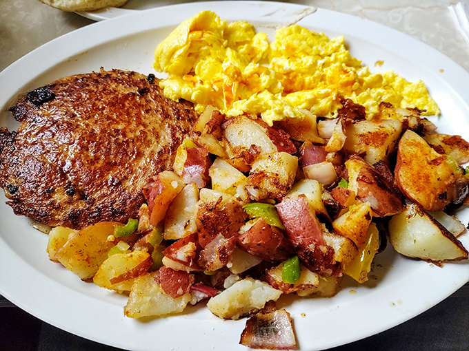 Breakfast alchemy at its finest: perfectly seasoned country potatoes, scrambled eggs, and a hamburger patty that means business.