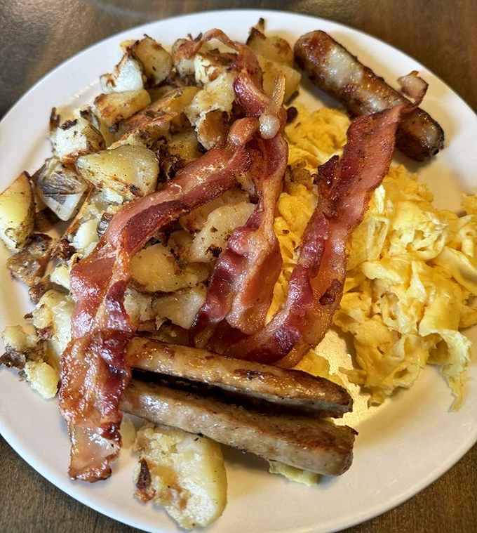 Breakfast nirvana achieved! Golden home fries, perfectly scrambled eggs, and bacon that strikes that magical balance between crispy and chewy.