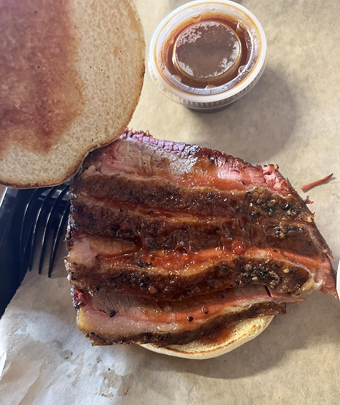 Brisket so perfectly barked and tender it could make a vegetarian question their life choices. The smoke ring is practically a halo.