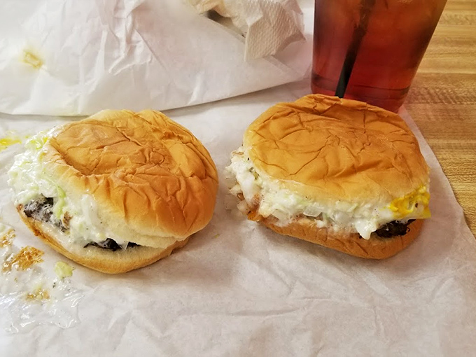 Two perfect specimens of burger artistry, wrapped in wax paper like the precious gifts they are. Simplicity has never looked so mouthwatering.