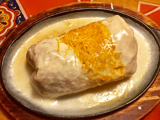 Behold the burrito in its natural habitat&mdash;swimming in a pool of queso. This isn't just dinner; it's therapy wrapped in a tortilla. 