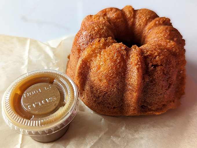 This golden bundt cake isn't just dessert&mdash;it's architecture with purpose. The caramel sauce alongside is basically liquid gold that would make King Midas jealous.