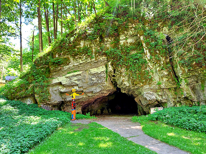 The cave entrance peeks out from beneath a curtain of greenery, like Earth decided to partially reveal one of its best-kept secrets.