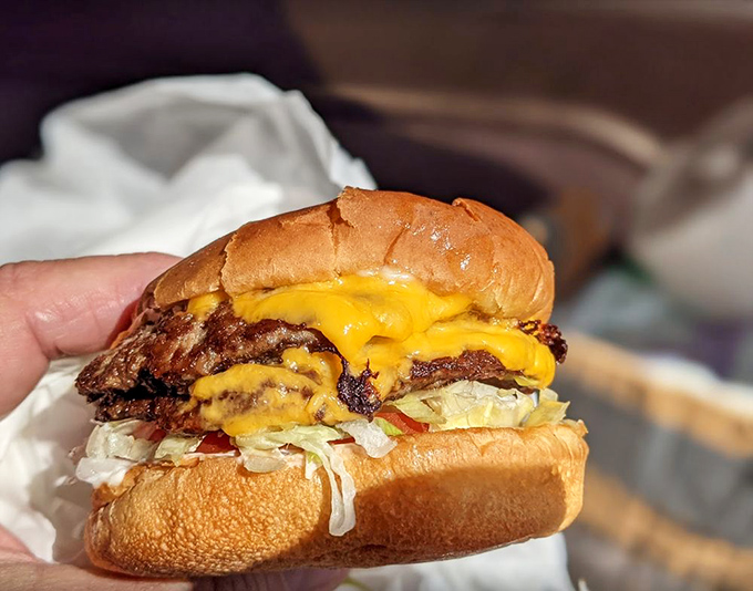 Crispy-edged patty meets melted American cheese in perfect harmony - this isn't just a cheeseburger, it's a California institution.