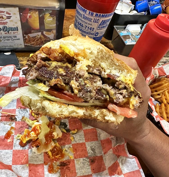 This isn't just a burger; it's edible architecture. Layer upon delicious layer of beef, cheese, and toppings that require both hands and several napkins.