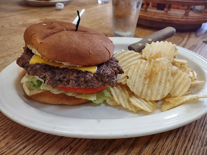 The star of the show in all its glory – a hand-formed patty, melted cheese, and fresh toppings on a soft bun. Simplicity perfected.