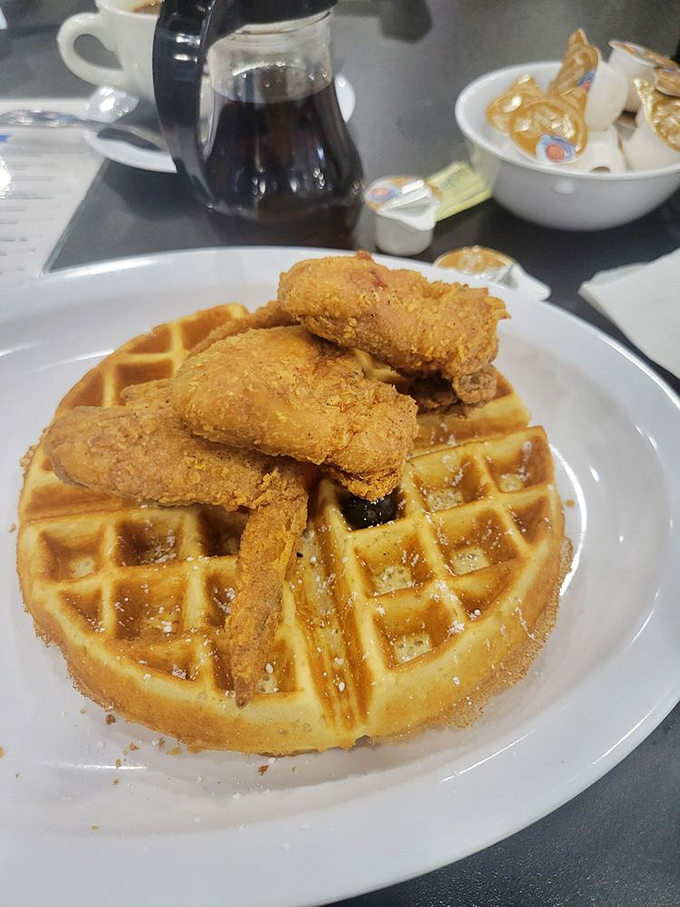 Golden-fried chicken perched atop a Belgian waffle like a crispy crown. The sweet-savory combo that makes morning people out of night owls.