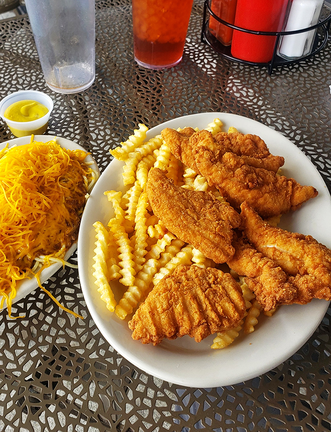 Golden-fried chicken tenders that could make the Colonel jealous, served with a mountain of cheese and crinkle-cut fries that demand to be savored.
