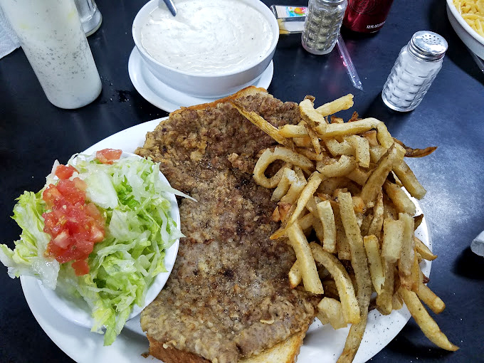 Behold the star attraction: a chicken fried steak that hangs off the plate like Texas itself &ndash; big, bold, and unapologetically delicious.