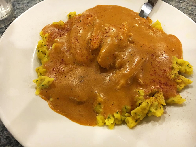 Behold the legendary chicken paprikash! Tender chicken swimming in paprika-infused sauce atop homemade spaetzle&mdash;Hungarian grandmothers everywhere would approve.