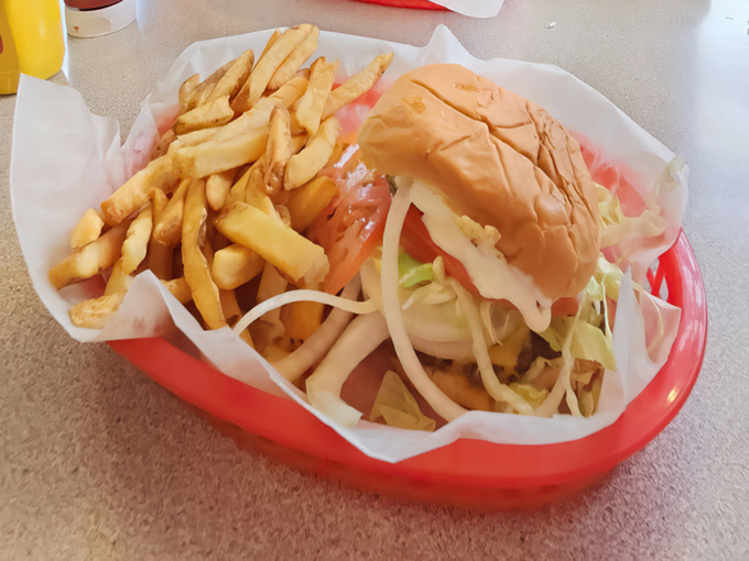 A sandwich so perfectly constructed it deserves its own architectural award&mdash;crisp fries standing guard beside the main attraction.