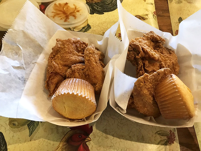 Golden-brown chicken perfection nestled in paper baskets alongside cornbread muffins&mdash;proof that simplicity, when executed flawlessly, creates the most profound food memories.