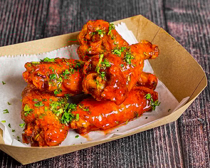 These wings aren't just flying high—they're soaring into flavor stratosphere. Glistening with sauce and sprinkled with fresh herbs, they're Miami's answer to Buffalo's finest.