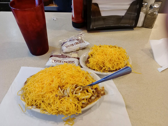 Cincinnati-style chili in all its glory – a mountain of finely shredded cheddar atop spaghetti and that distinctive spiced meat sauce. Resistance is futile.
