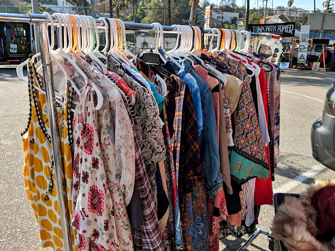 Vintage dresses hang like colorful memories, each one waiting to tell its next chapter.