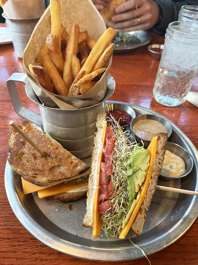 This isn't just a sandwich&mdash;it's an architectural marvel of flavor, where crispy fries stand at attention beside layers of fresh vegetables.