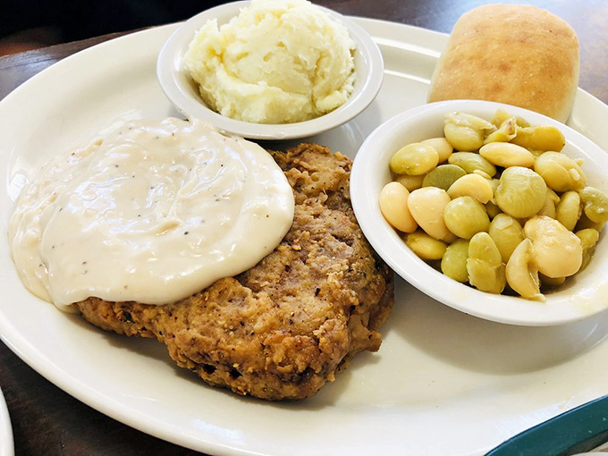 Country fried steak that could make a vegetarian weep with temptation. That pepper gravy blanket isn't just covering the steak&mdash;it's tucking it in for a flavor nap.