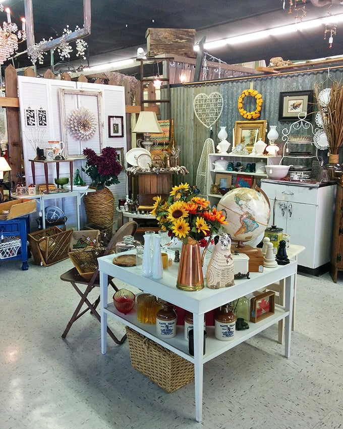 A perfectly curated vignette that makes you wonder if you've wandered onto a movie set. Sunflowers and vintage globes&mdash;who could resist?