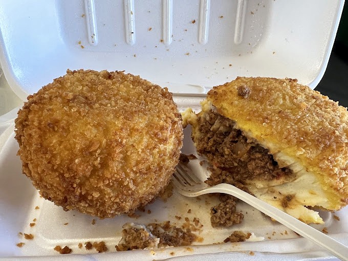 Golden-brown deviled crabs that could make a seafood skeptic weep with joy. These crispy orbs of seasoned blue crab are Tampa's edible treasure.